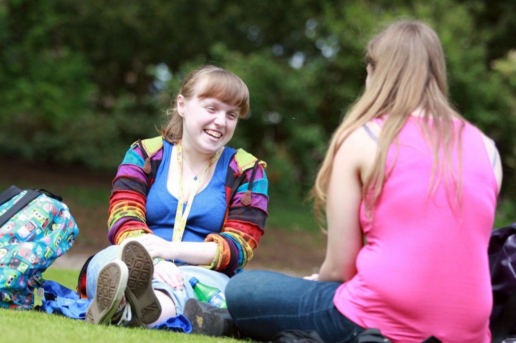 Student Welfare - students relax on the lawn - Reaseheath College