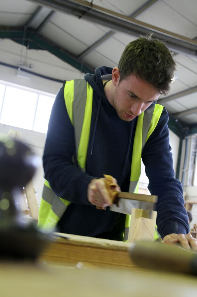 Construction - student sawing - Reaseheath College