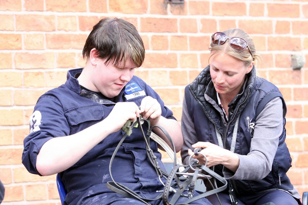 Foundation student checking bridle - Reaseheath College