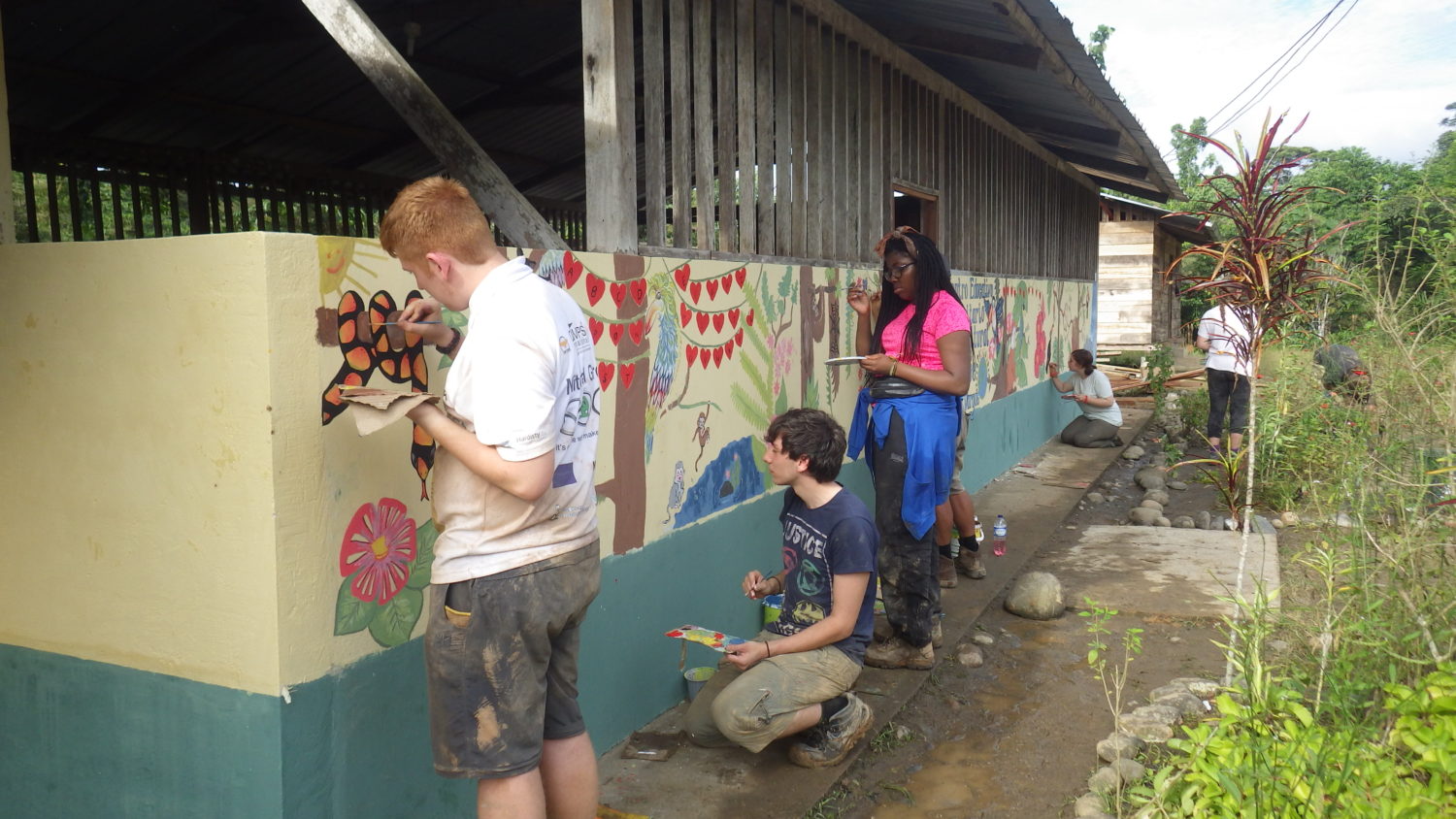 Jack and fellow volunteers decorate the exterior of a primary school in ...