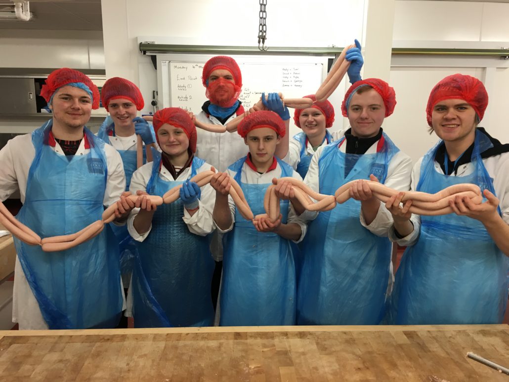The butchery apprentices show off the links of sausages they made during National Apprenticeship ...